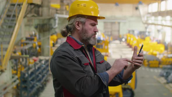 Industrial Worker Using Smartphone in Factory, Stock Footage | VideoHive