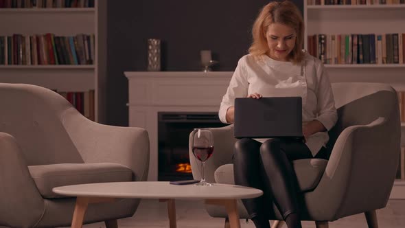 Adult Female Using Computer Relish Drink in Living Room, Stock Footage