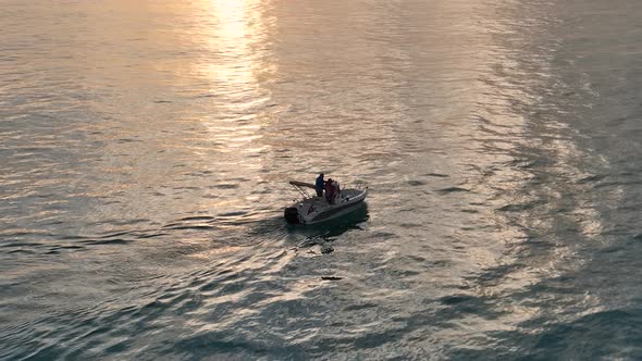 Fishing boat far out to sea at sunset, Stock Footage | VideoHive