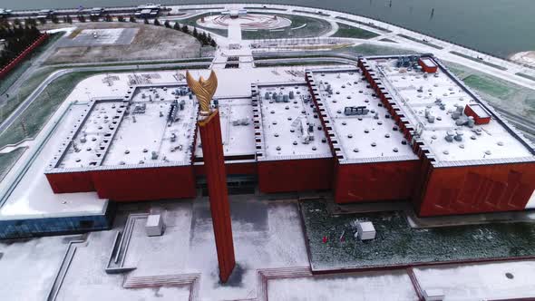 High Red Stele with Olympic Torch in Front of Sports Complex, Stock Footage