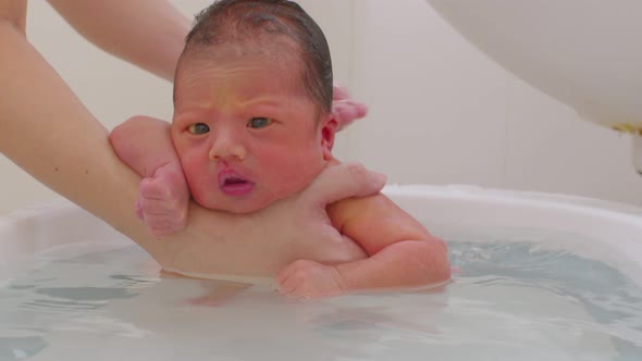 Calm of asian newborn baby bathing in bathtub, Stock Footage | VideoHive