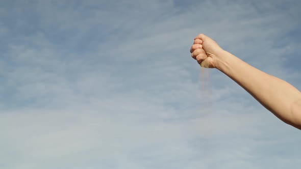 Gimbal Shot of Woman Hand with Crumbling Sand on Sky Background, Stock ...
