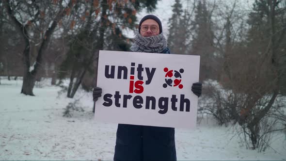 An Activist is Carrying a Placard Unity is Strength for people to get ...
