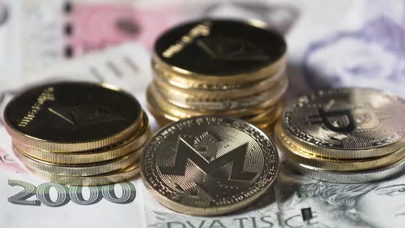 Monero and other stacked cryptocurrency coins on Czech crown banknotes ...