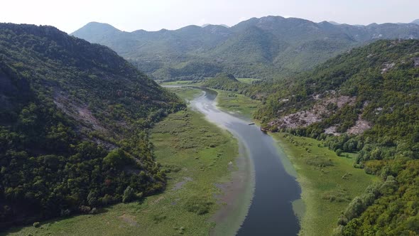 River Flowing Along the Valley Between Two Mountain Ranges, Stock Footage
