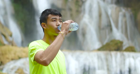 Man Drinking Water, Waterfall at Background, Stock Footage | VideoHive