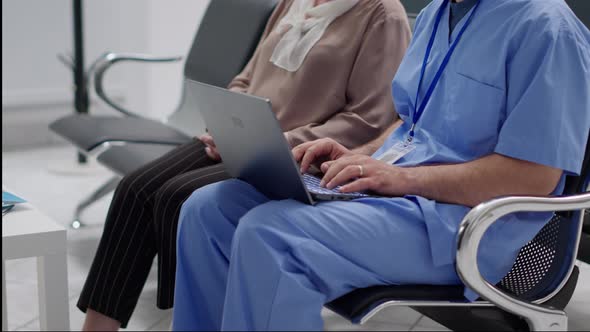 Medical Assistant Working on Laptop to Give Diagnosis to Old Patient ...