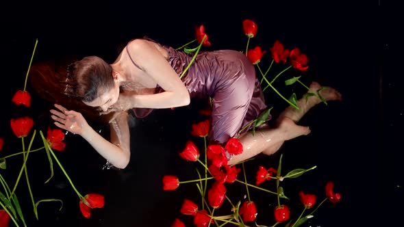 Sensual Redhaired Woman is Lying in Water of Lake or River with Red ...