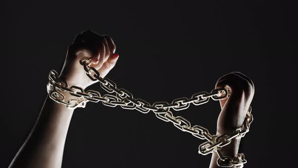 Hands breaking chains. Metal or steel chain is blown to pieces. Break ...