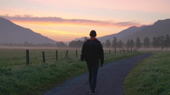 Man Walking Along Path Towards Misty Landscape At Dawn, Stock Footage