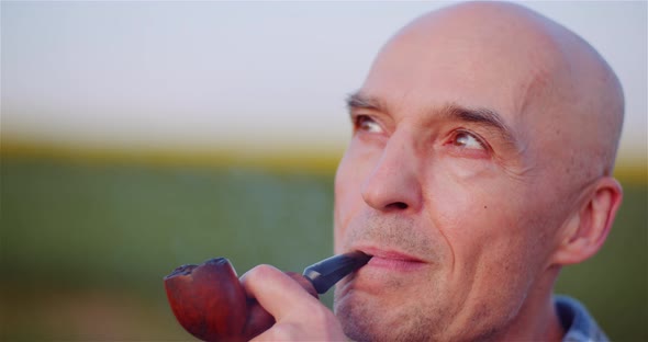 Contented Bald Farmer Smoking His Pipe On Field, Stock Footage | VideoHive
