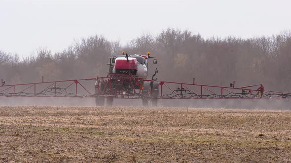 Vehicle spraying farmland with a liquid herbicide and pesticide on a ...