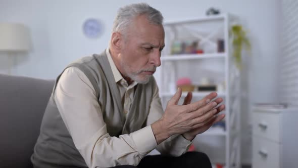 Old Man Looking at Hand Trembling, Distressed by Tremor, Early ...