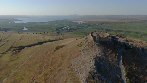 Drone tracking shot with front side of Enisala, medieval fortress on ...
