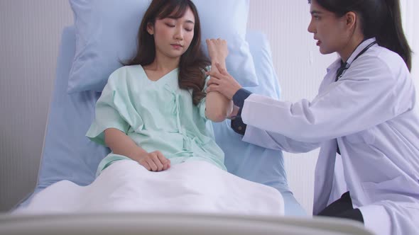 Female doctor checking up patient's body after recuperating from ...
