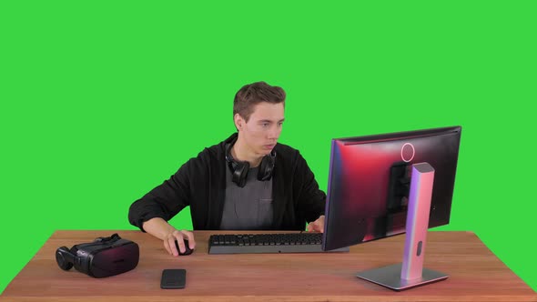 Gamer Playing a Video Game on Personal Computer on a Green Screen ...