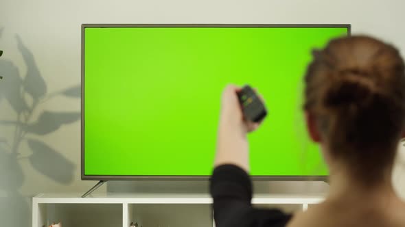 Woman Watching TV with Green Screen in Living Room Back View, Stock Footage