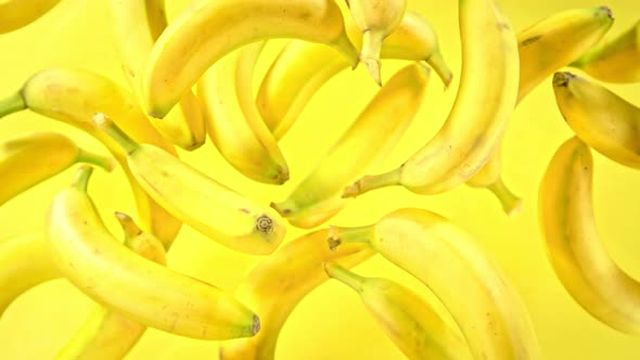 Super Slow Motion Shot of Fresh Bananas on Yellow Background Flying ...