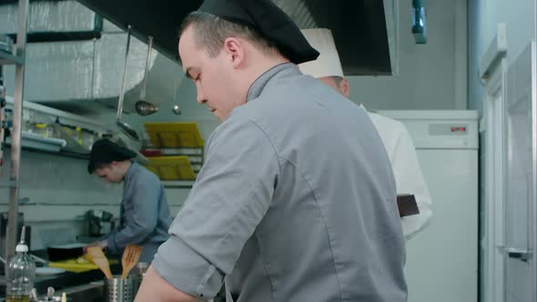 Trainee Cook Putting Champignons on a Frying Pan, Stock Footage | VideoHive