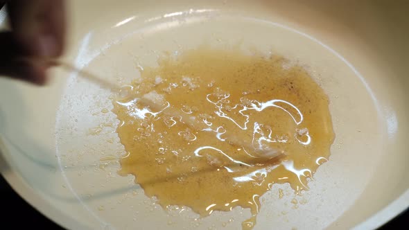 Sugar caramelizing in hot frying pan. Making home brown sugar candy ...
