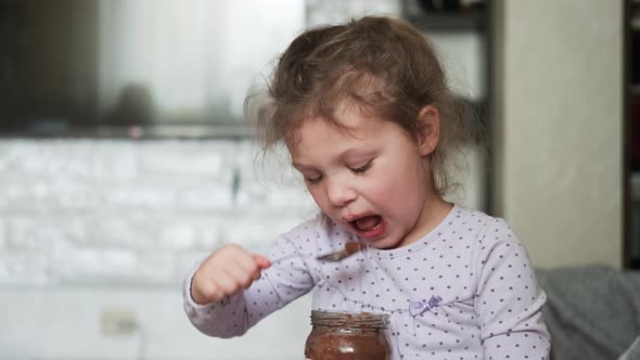 Children Eat Chocolate Paste with a Spoon From a Jar, Stock Footage