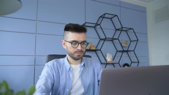 Focused business man entrepreneur typing on laptop doing research ...