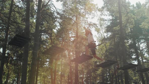 Brave Teenage Girl Overcoming Obstacles in a Rope Park, Stock Footage