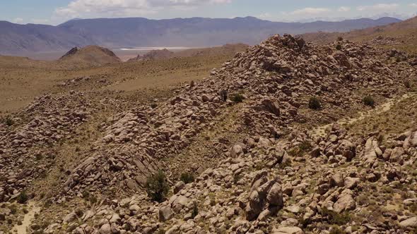 Aerial shot of interesting rock formations in the desert of California ...