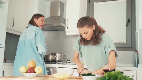Two Young Pretty Women Singing and Dancing While Cooking in the Bright ...