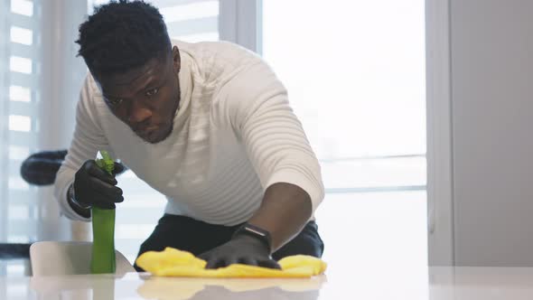 Black Man Spraying Cleaning and Disinfecting Table Surface, Stock Footage