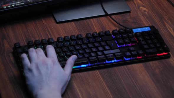 Gamer Typing on Backlight Keyboard Closeup Man Playing Video Game ...