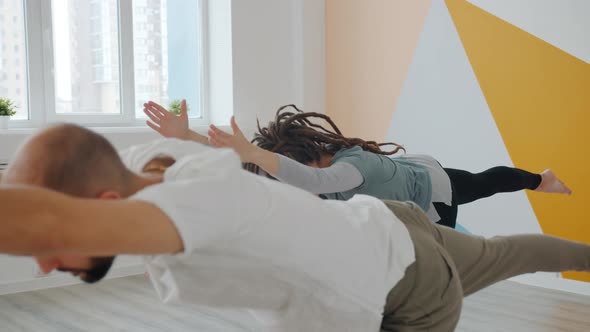 Yoga Students Male and Female Concentrated on Balancing Asanas in Cozy ...