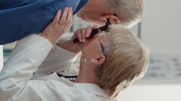 Vertical Video Otolaryngology Specialist Using Otoscope to Examine Ear ...