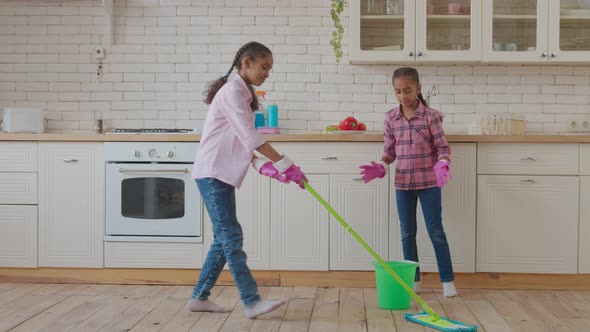 Housekeeping Mixed Race Sisters Swabbing Down Floor, Stock Footage