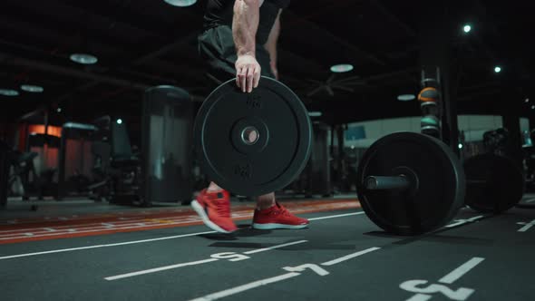 Bodybuilder Carrying Barbell Plate in Gym, Stock Footage | VideoHive