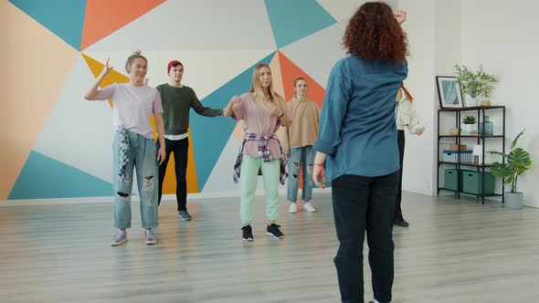 Cheerful Teenagers Learning Dancing Moves From Professional Dancer in ...
