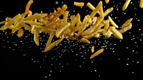 Slow Motion of Flying Fresh French Fries on Black Background., Stock ...