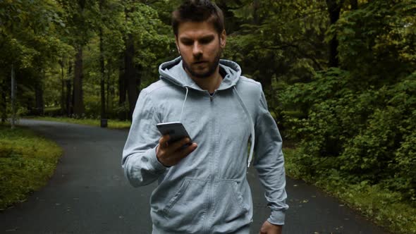 Clumsy Sportsman Dropping Smart Phone While Running, Stock Footage