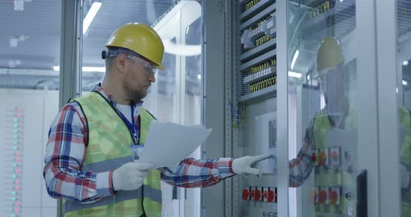 Electrical Worker Reading Paperwork and Inspecting Equipment, Stock Footage