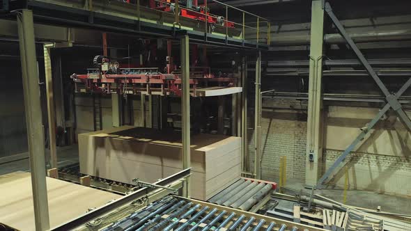 A Machine is Folding Finished Chipboard Plates at the Factory, Stock ...