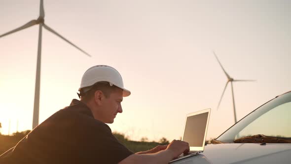 Technician Engineer Working at Wind Turbine Using Laptop Computer ...