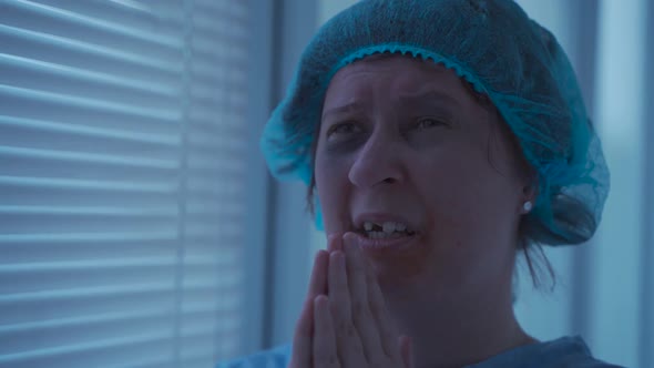 Stressed Woman with Facial Injuries Crying and Praying in Hospital ...
