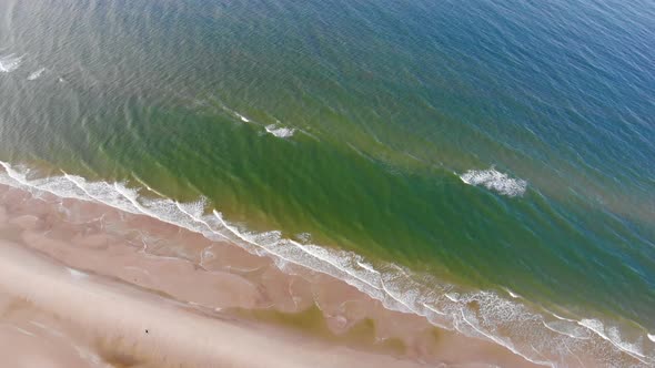 Aerial view of the North Sea shoreline with rolling waves outside ...