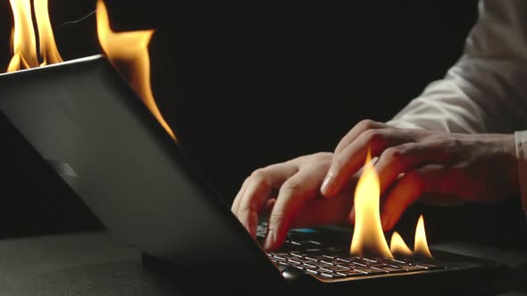 Businessman Is Typing On Burning Laptop - Slow Motion, Stock Footage