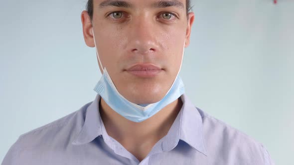 Slow motion of a Young Man Wearing a Face Mask Below Chin, Closeup ...