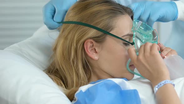 Hospital Nurse Helping Sick Woman to Put on Oxygen Mask, Respiratory ...