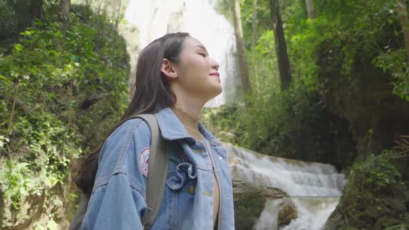Woman Breathing Deep Fresh Air In Front Of A Waterfall, Stock Footage