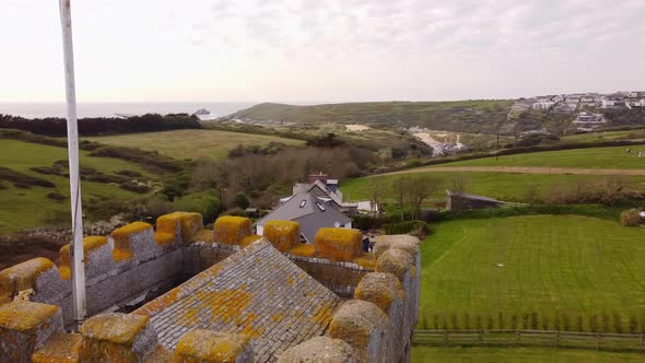 Aerial Crantock Village Church spire revealing Crantock Beach in ...