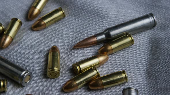 Cinematic rotating shot of bullets on a fabric surface - BULLETS 091 ...