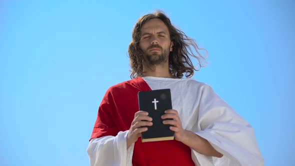 Strict God Holding Bible Against Blue Sky, Reminding of Faith and ...